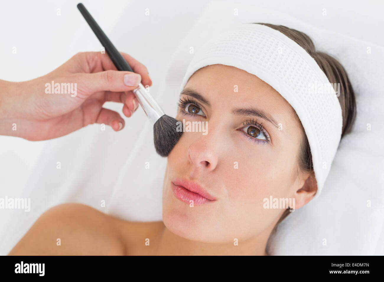 Hand applying blush to beautiful woman Stock Photo - Alamy