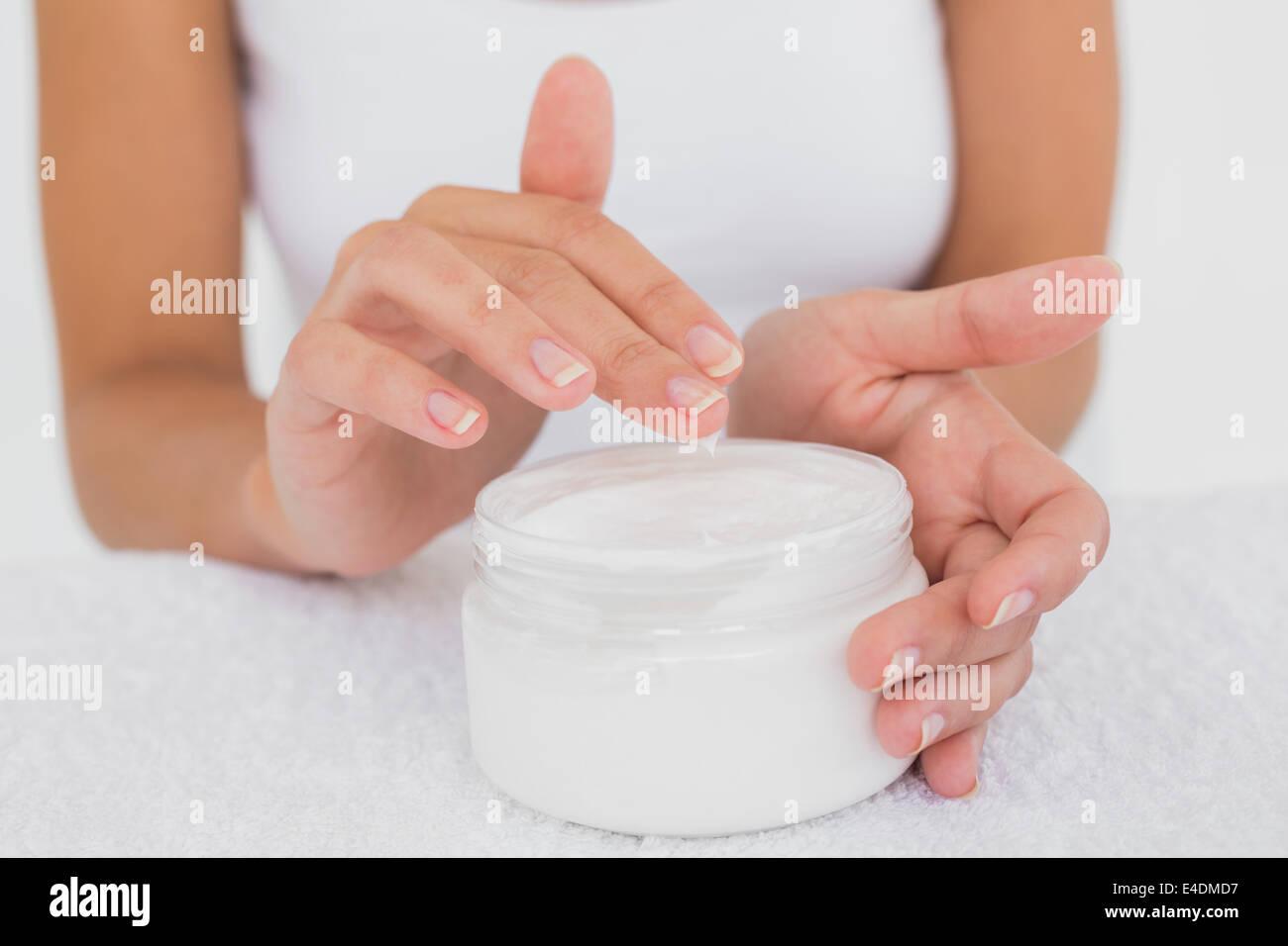 Mid section of woman applying cream Stock Photo - Alamy