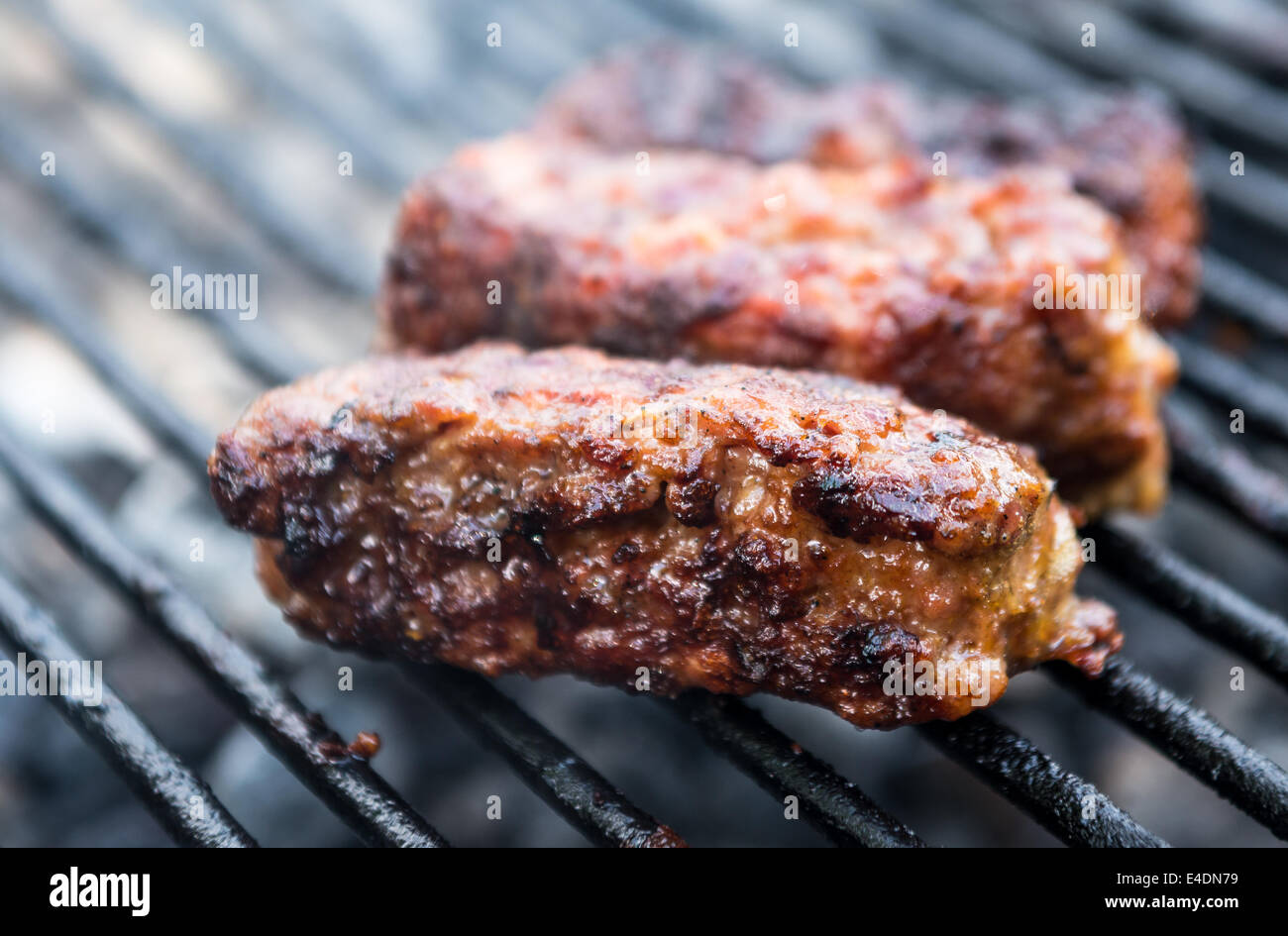 Traditional Romanian food, barbecue with grilled meat rolls, mititei or ...