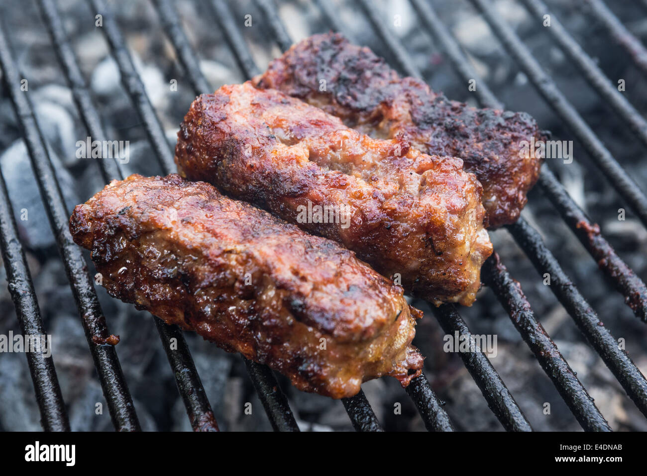 Traditional Romanian food, barbecue with grilled meat rolls, mititei or ...