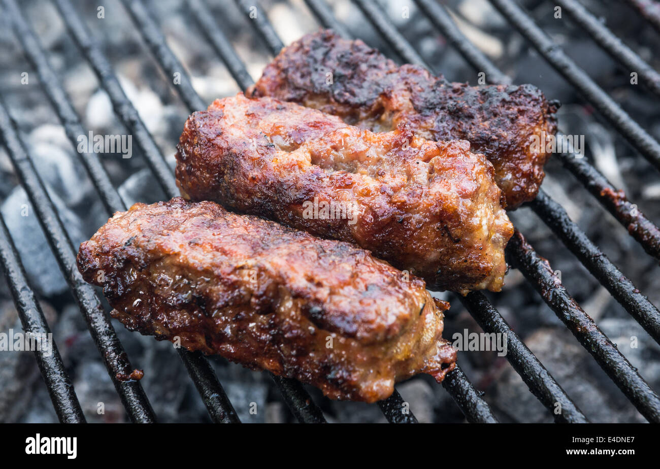 Traditional Romanian food, barbecue with grilled meat rolls, mititei or ...