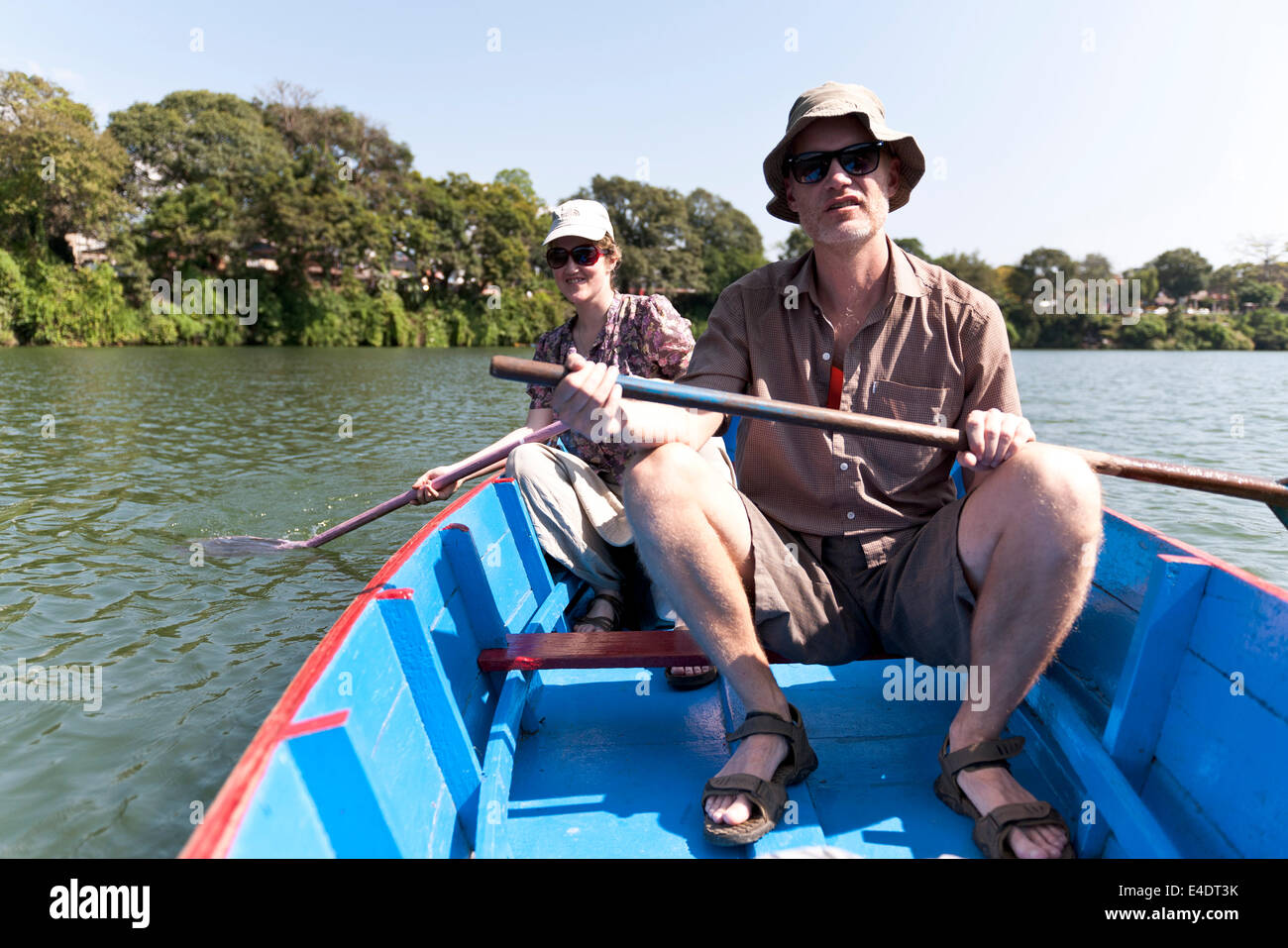 Couple rowing a boat in pokhara nepal Stock Photo - Alamy