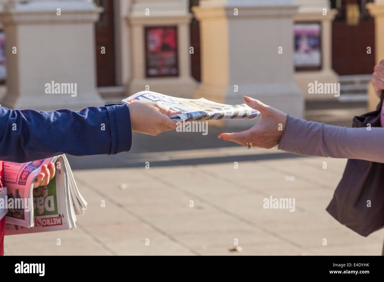 Handing out newspaper hi-res stock photography and images - Alamy