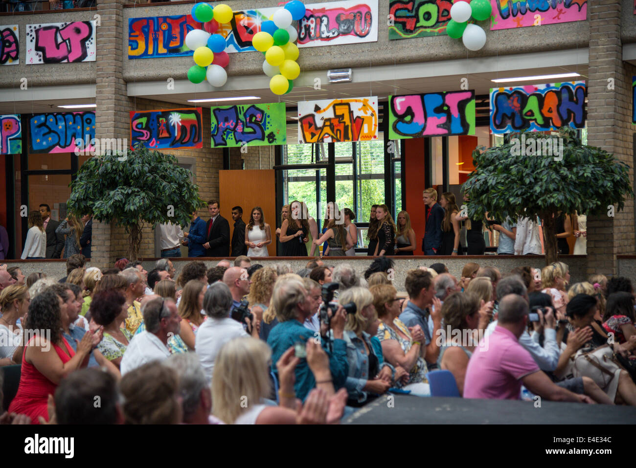 many parents in a highschool together to celebrate the scholars who ...