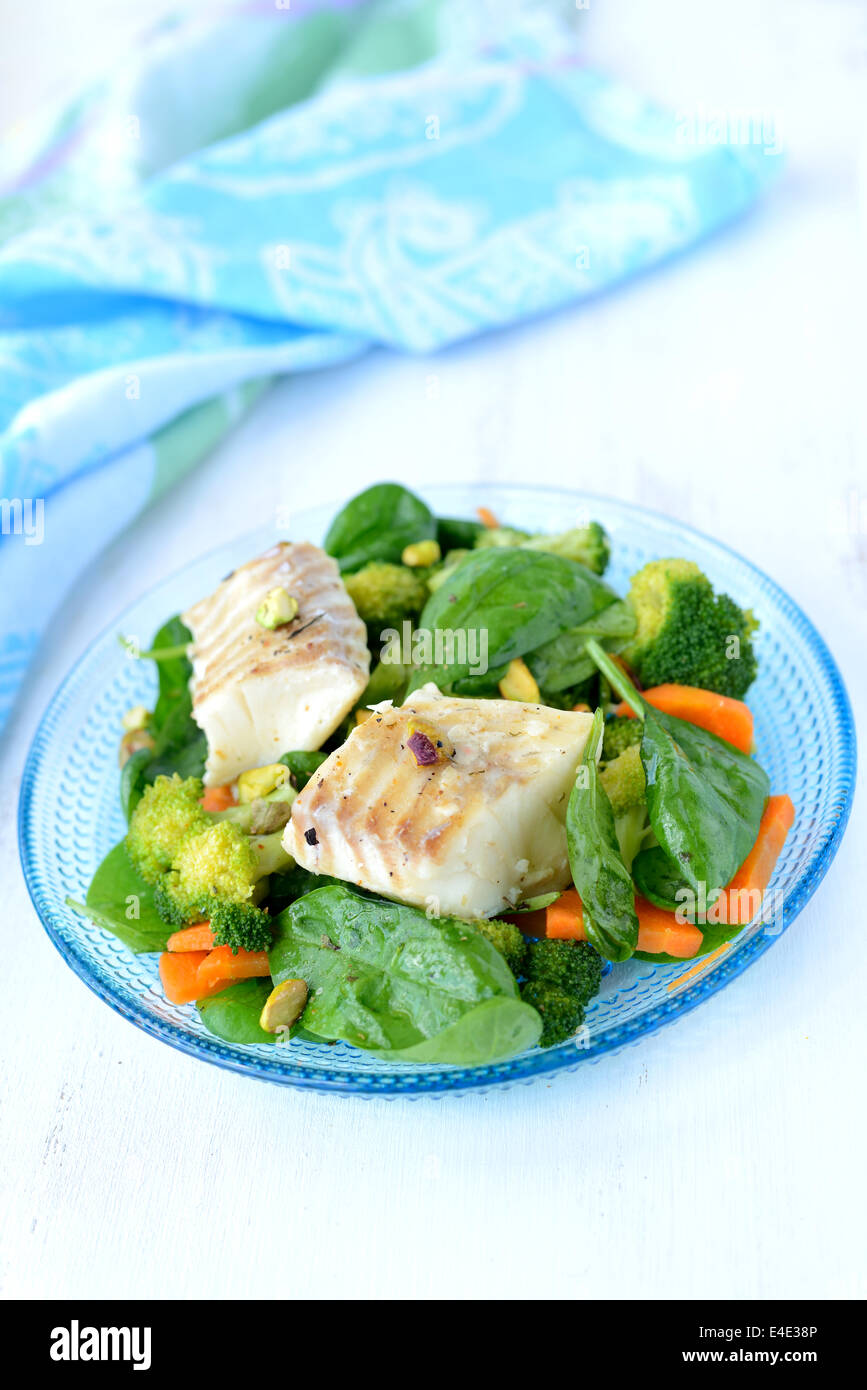 Braised fish (haddock) with vegetables. Salad is made of broccoli ...