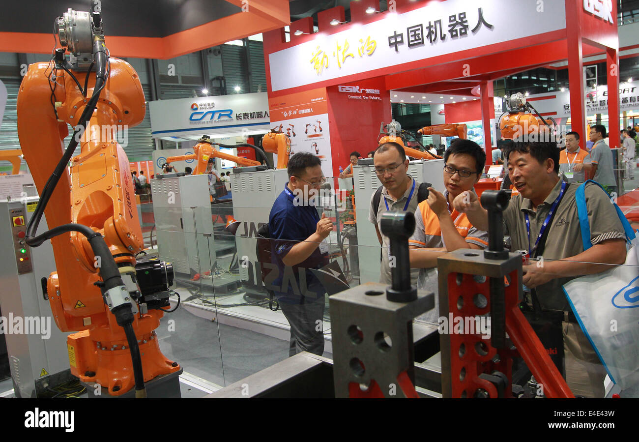 Shanghai, China. 9th July, 2014. Visitors look at a robot during the ...