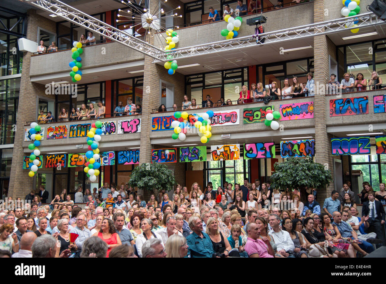 many parents in a highschool together to celebrate the scholars who ...