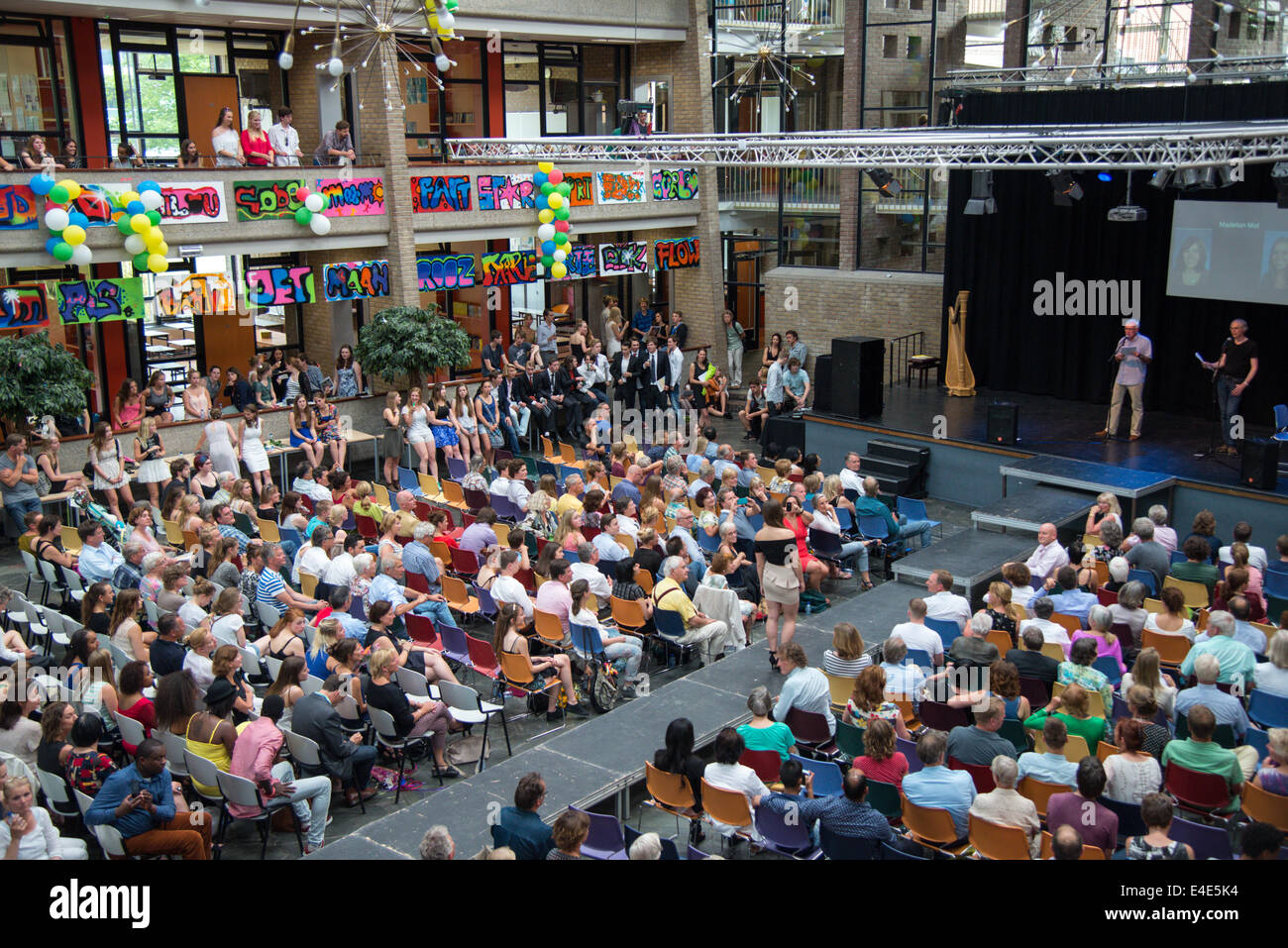 many parents in a highschool together to celebrate the scholars who ...