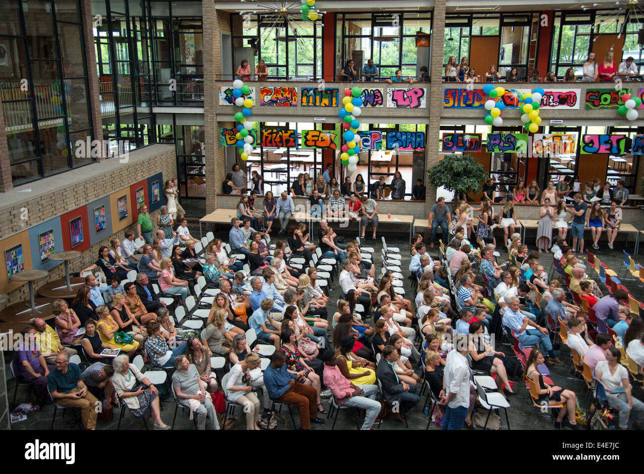 many parents in a highschool together to celebrate the scholars who ...