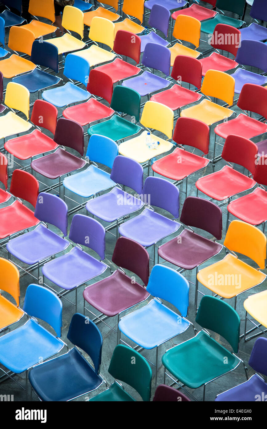 rows of colorful and empty plastic chairs in a school Stock Photo - Alamy