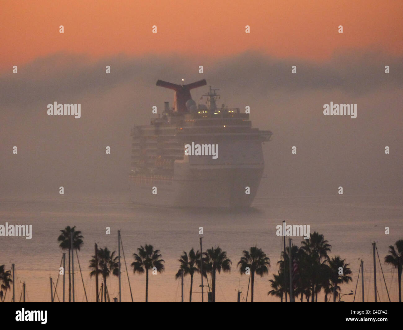 A cruise ship coming out of the mist into port early in the morning ...