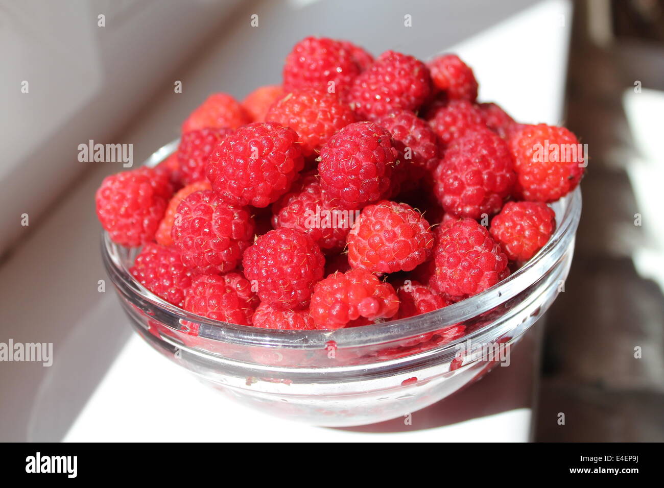 appetizing healthy juicy fresh raspberries into glass bowl Stock Photo ...