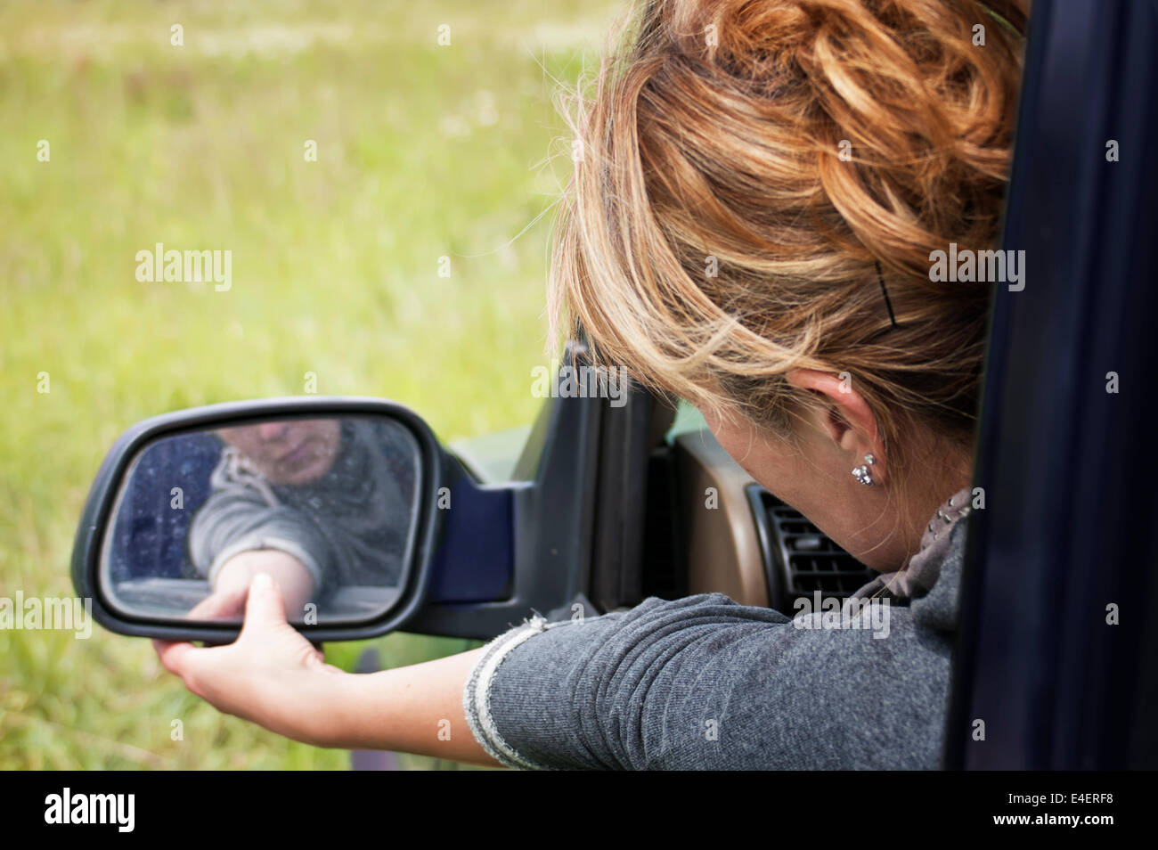 Female driver setting a side mirror Stock Photo - Alamy