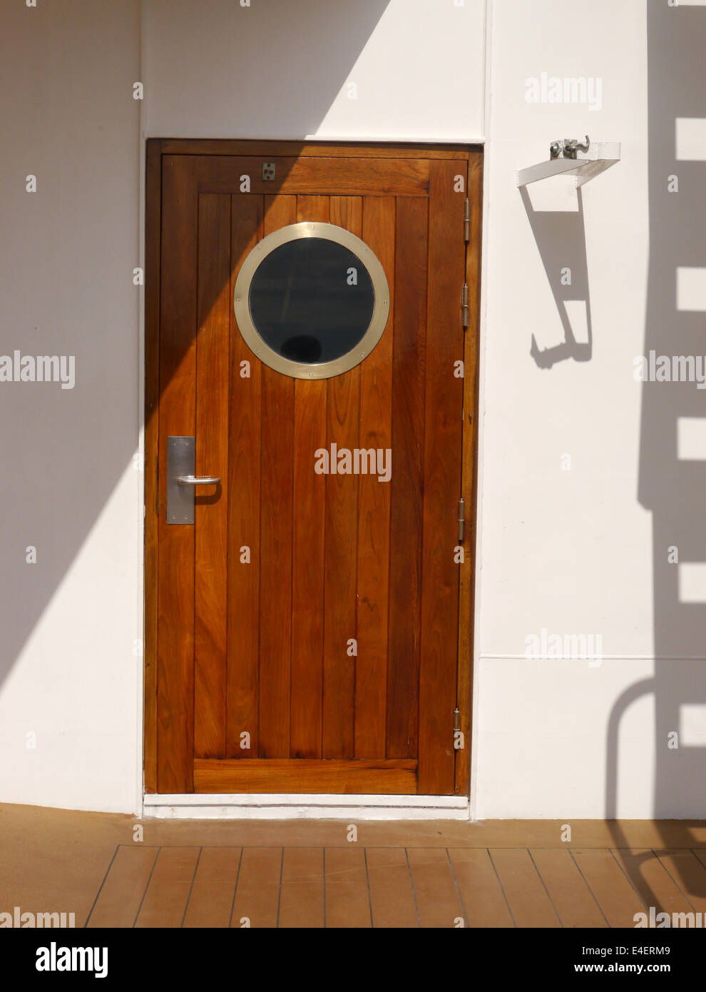 A varnished door with a porthole on the deck of a cruise ship Stock ...