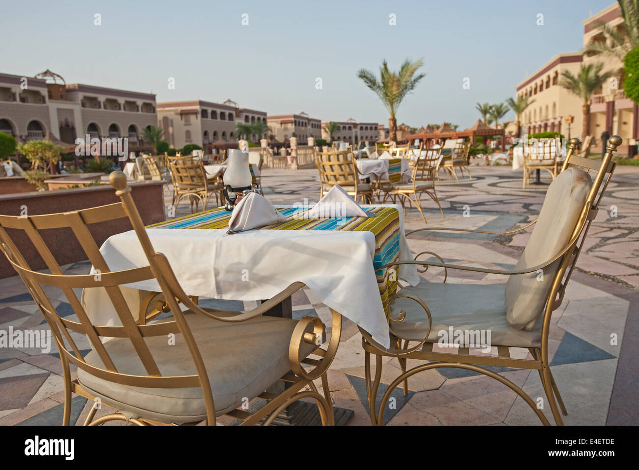 Tables and chairs in large luxury hotel outdoor restaurant Stock Photo ...