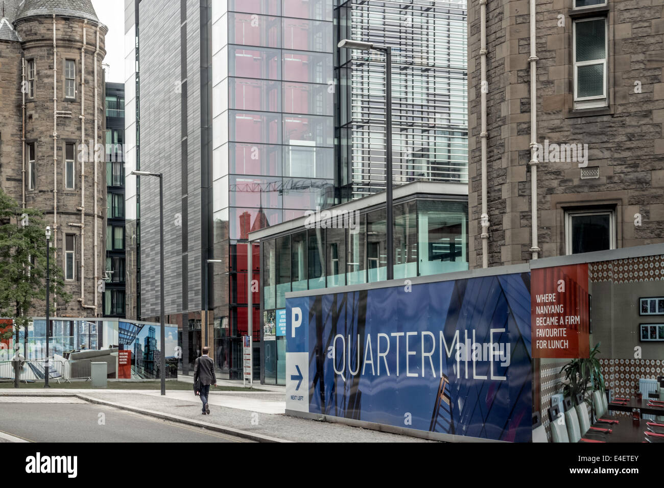 Business man walking along the street in Edinburgh's Quartermile ...