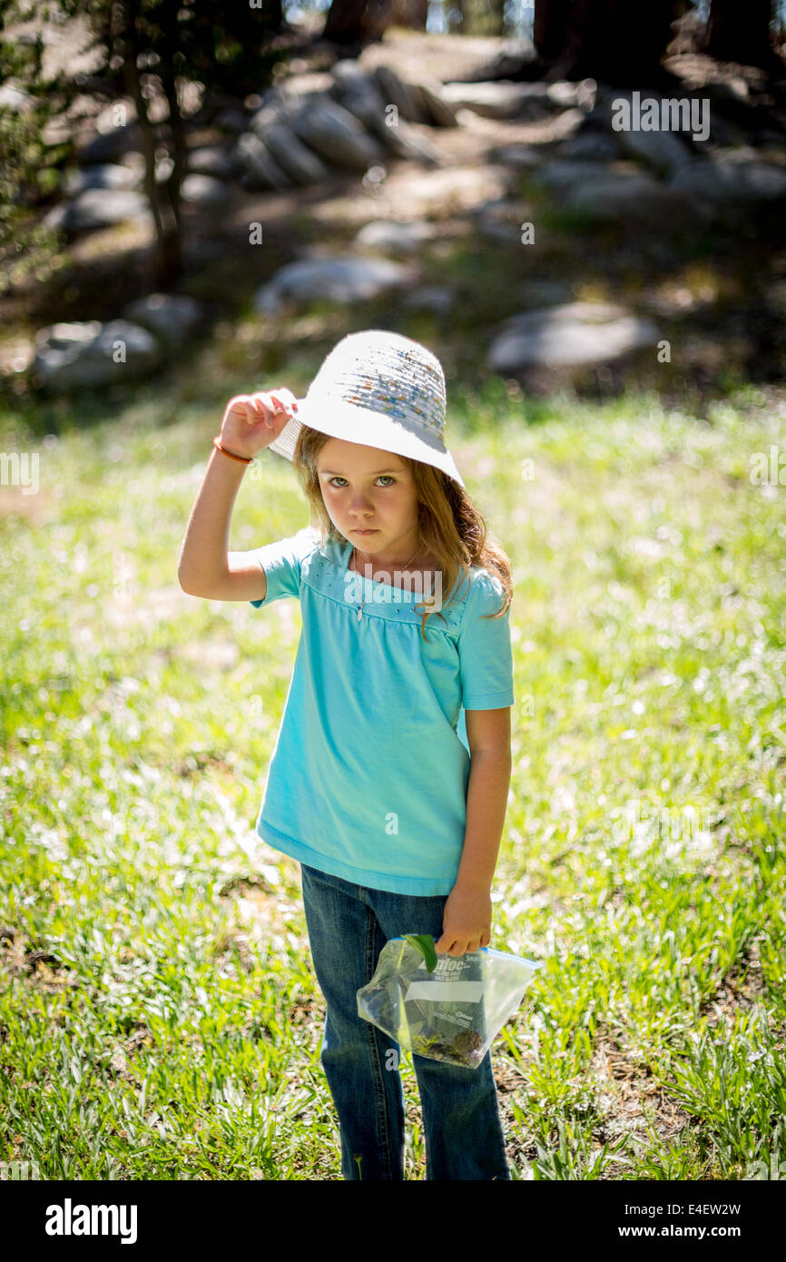 Girl collects rocks in a park Stock Photo - Alamy