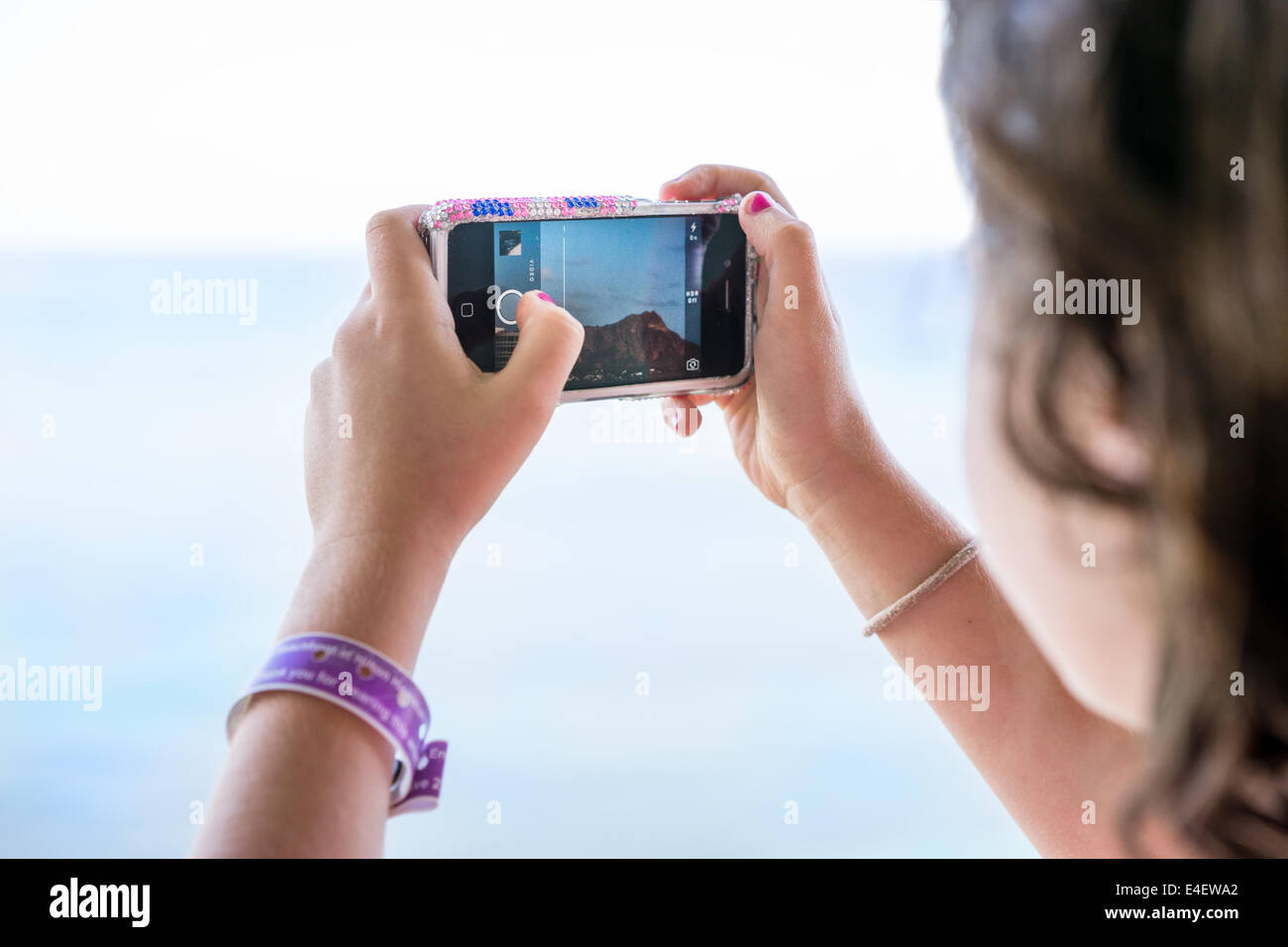 Girl takes a photo with her iPhone cellphone camera Stock Photo - Alamy