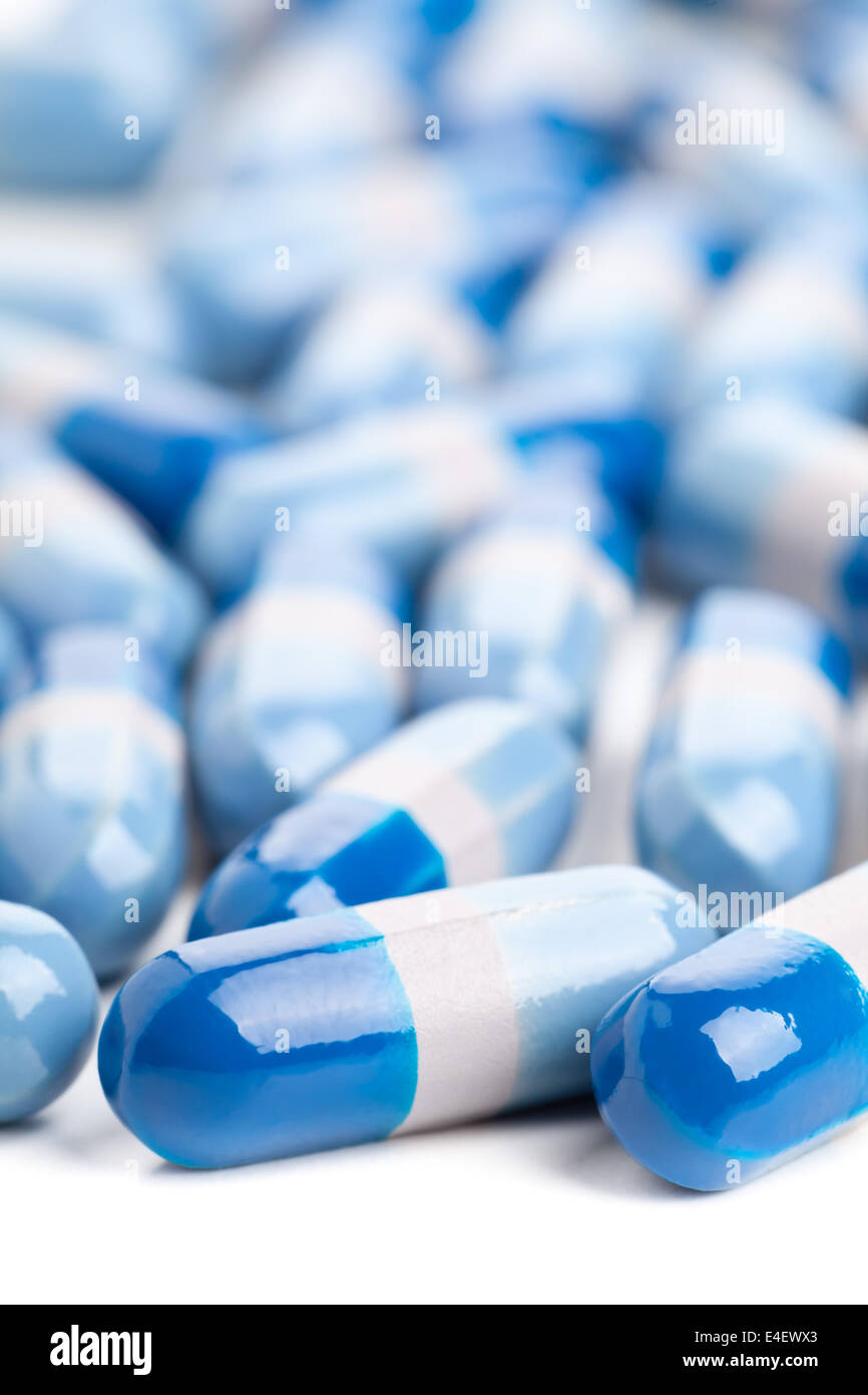 Heap of blue pills close up with selective focus Stock Photo - Alamy