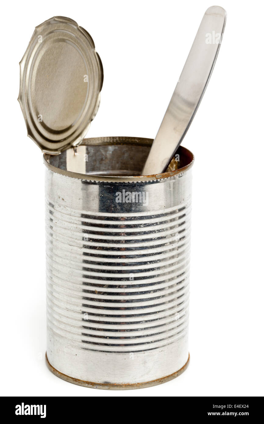 Empty canned food tin with spoon over white background - unhealthy ...