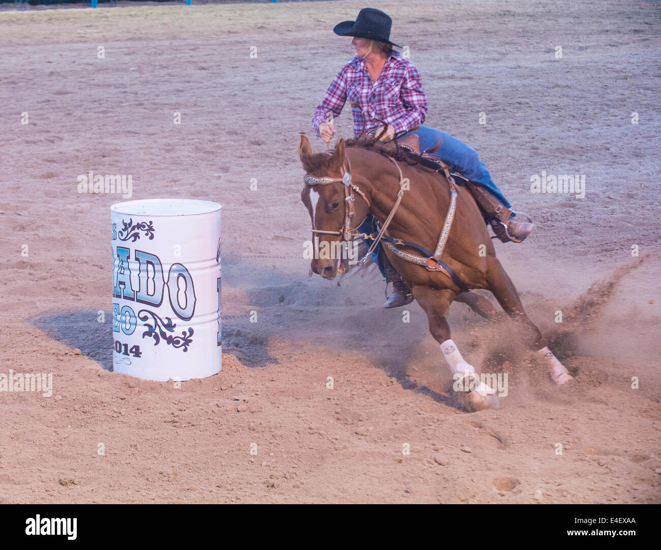 Cowgirl Participating in a Barrel racing competition at the Helldorado ...