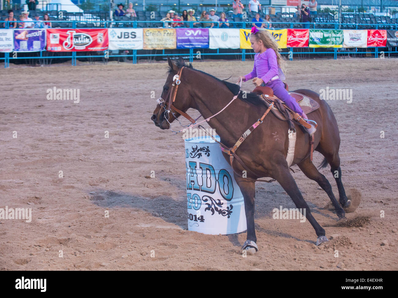 Cowgirl Participating in a Barrel racing competition at the Helldorado ...