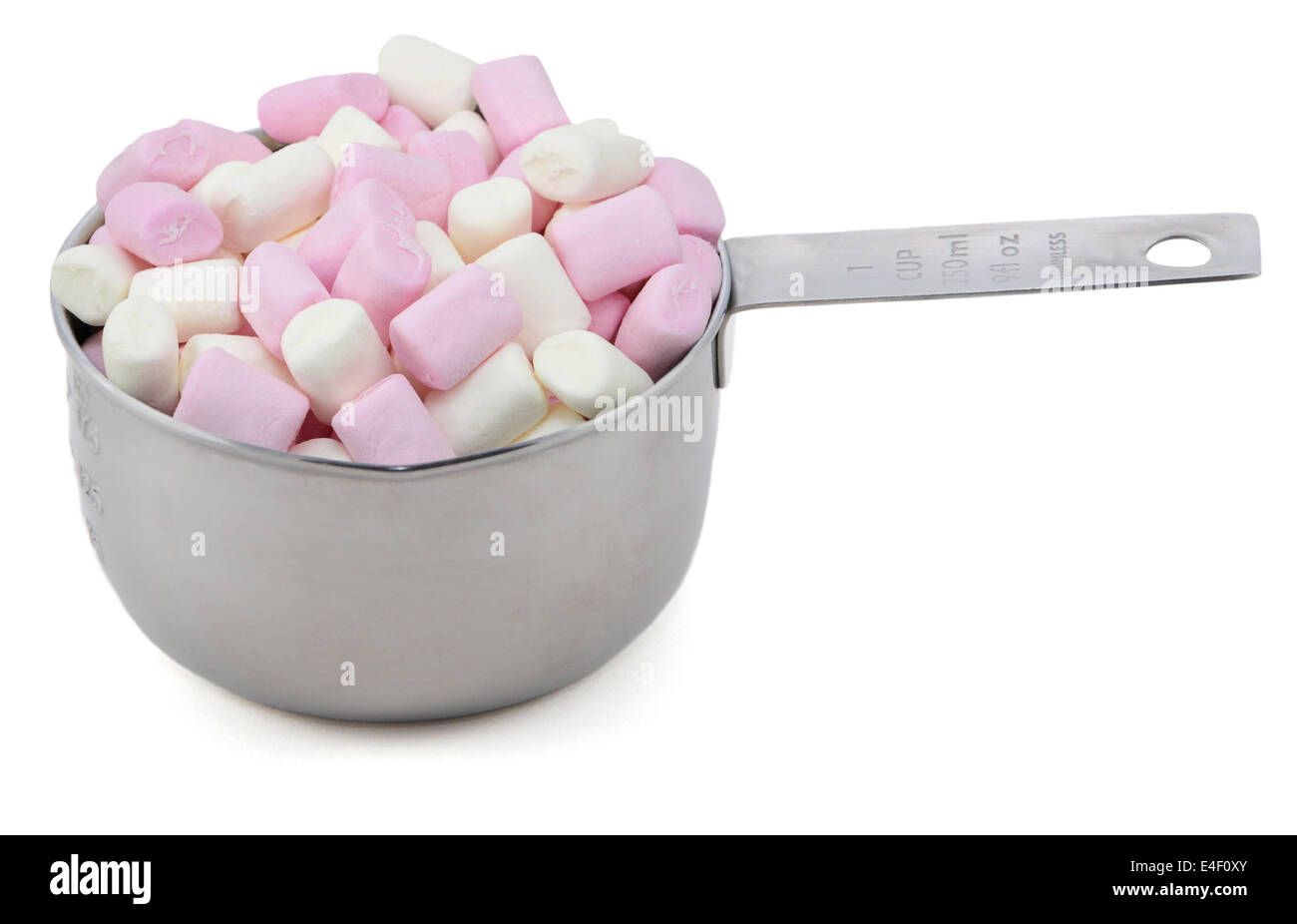 Pink and white mini marshmallows in an American cup measure, isolated ...