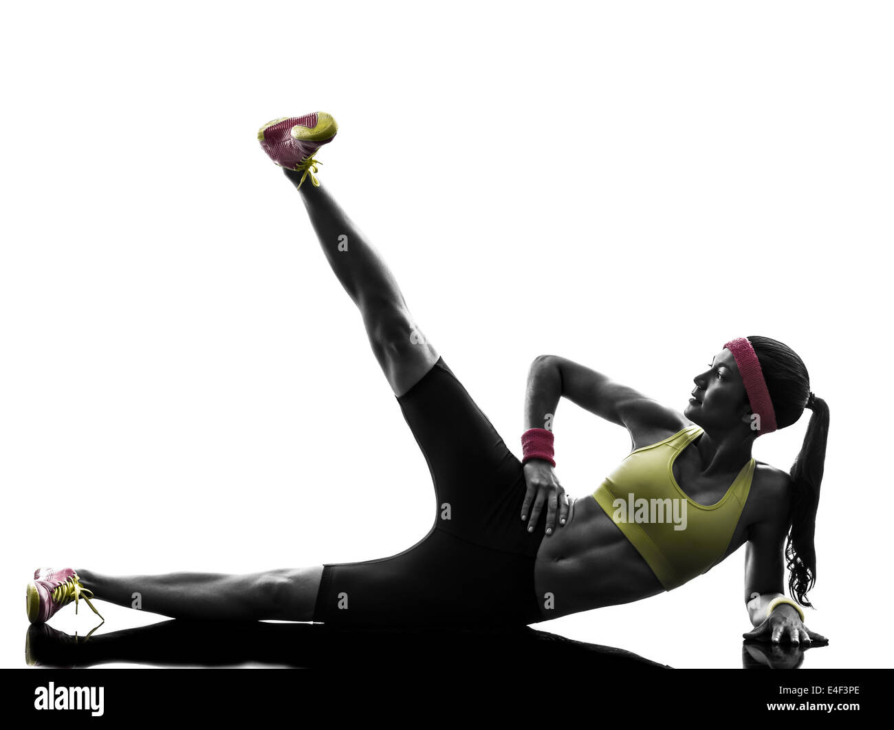 one woman exercising fitness workout legs in the air lying on side in ...