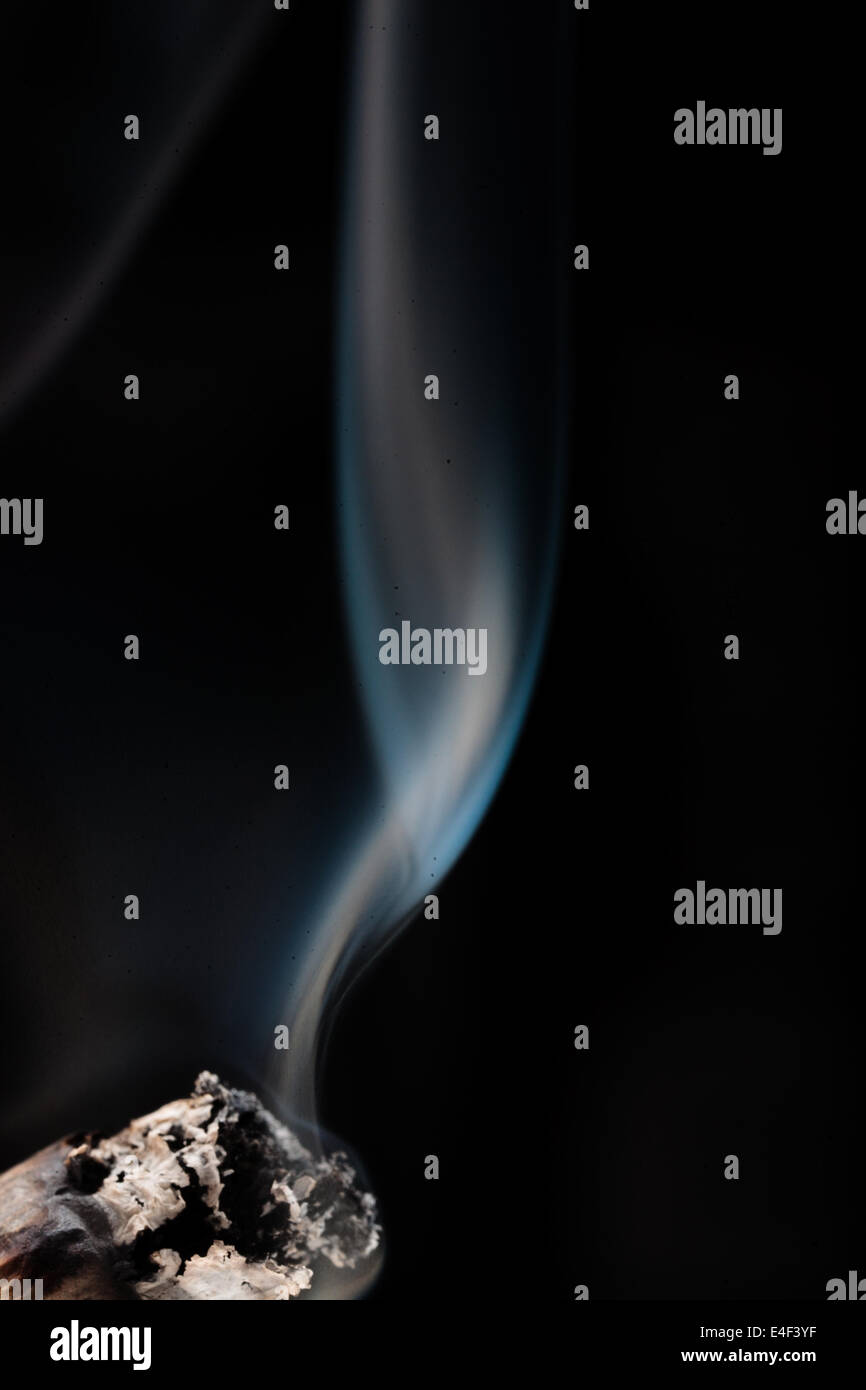 Smoke rising off a lit marijuana joint Stock Photo - Alamy