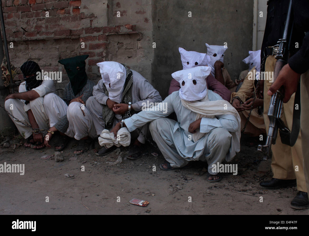The arrested Pakistani suspects with covered faces are under the police ...