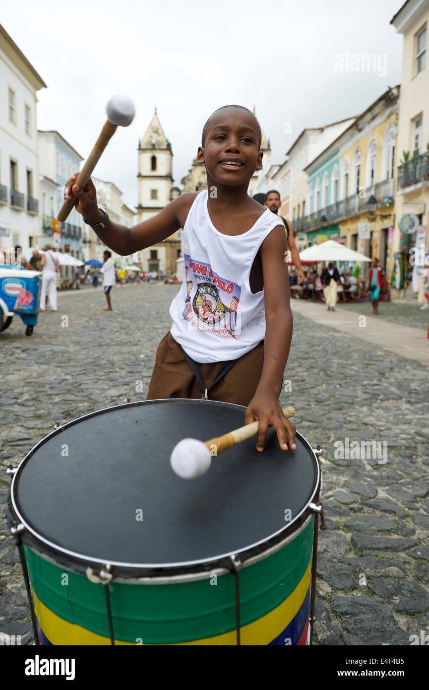 SALVADOR, BRAZIL - OCTOBER 15, 2013: Young Brazilian stands drumming on ...