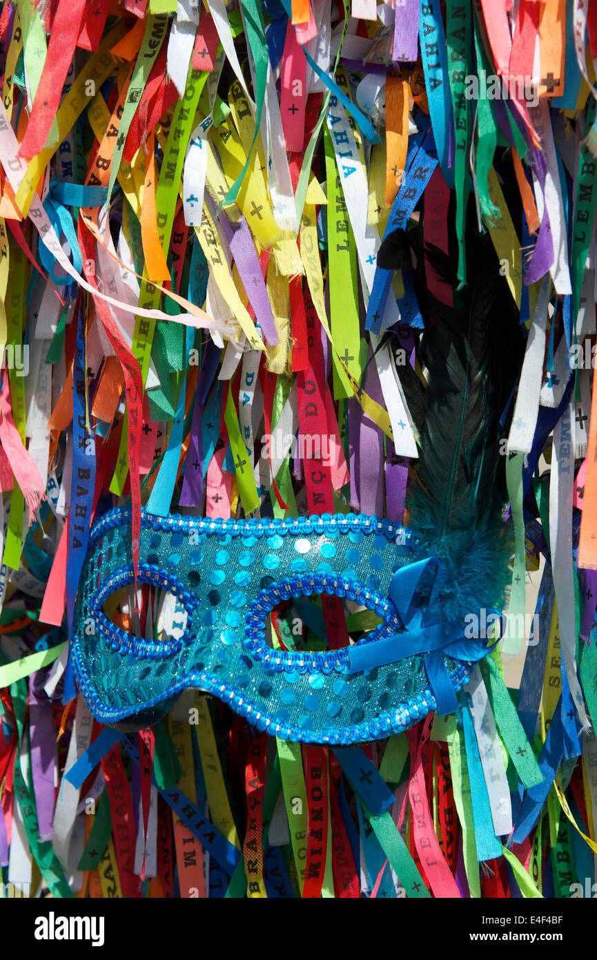 Blue sequined carnival mask in a background of Brazilian wish ribbons ...