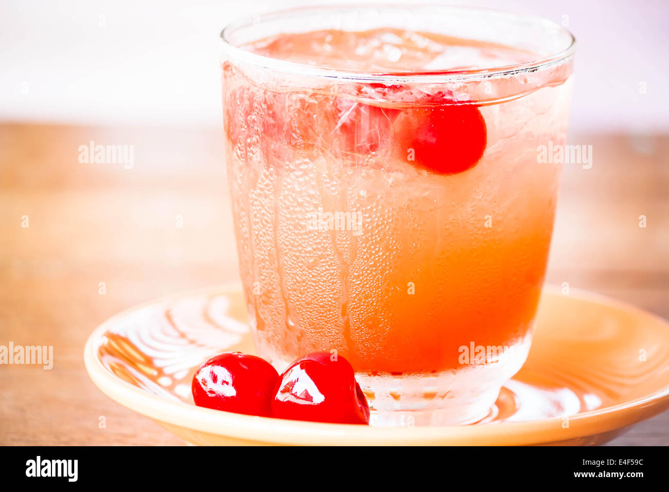 Glass of cold mix fruits juice soda on wood table Stock Photo - Alamy