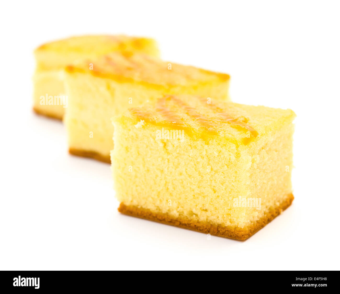 three pieces of sponge cakes on a white background Stock Photo - Alamy