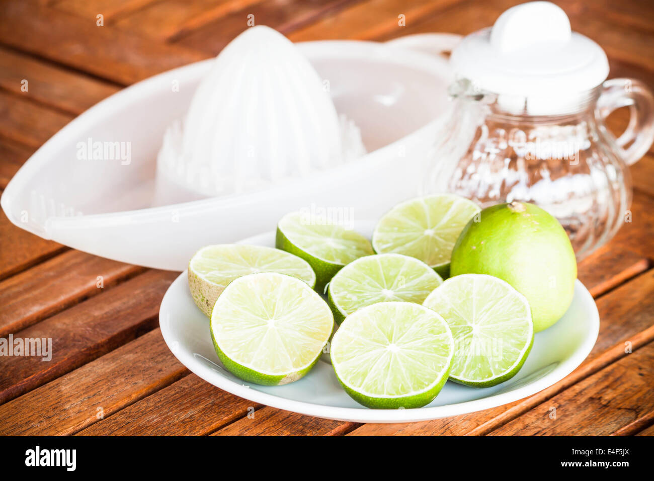 Fresh lime with glass jar and hand squash tool Stock Photo - Alamy