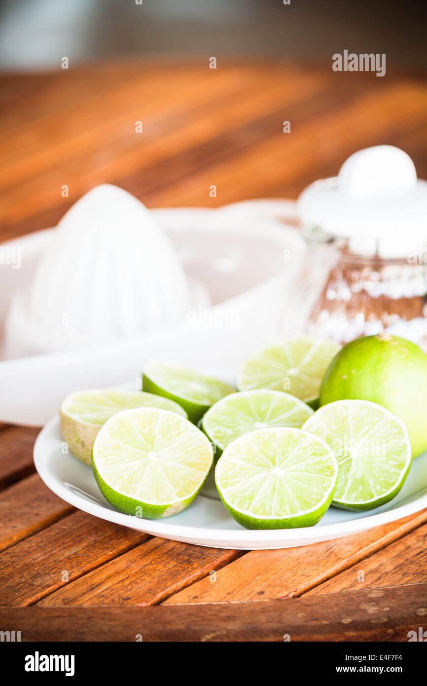 Fresh citrus lime wholes and slice with hand squash tool Stock Photo ...