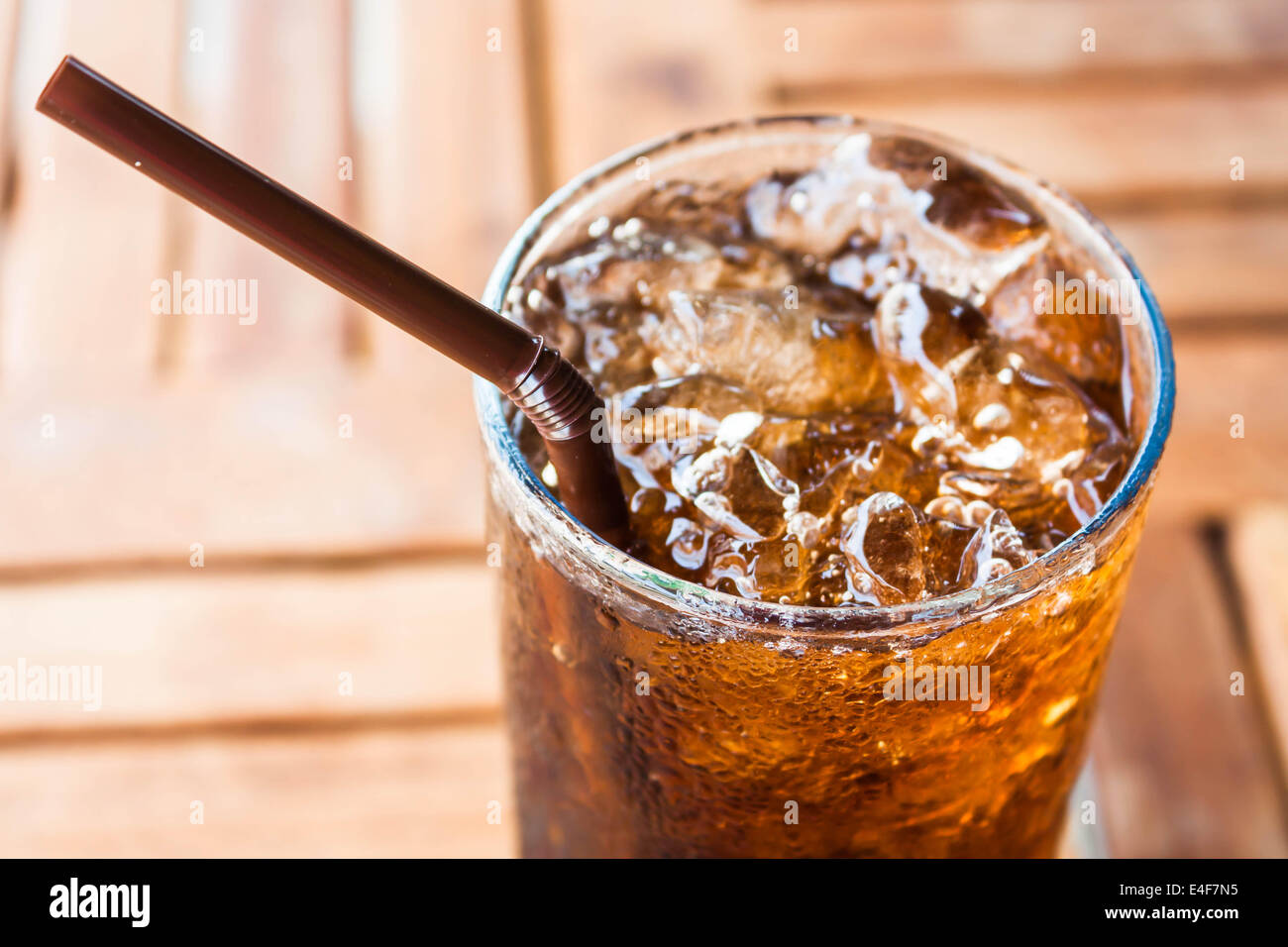 Cold glass with ice black soda drink Stock Photo - Alamy