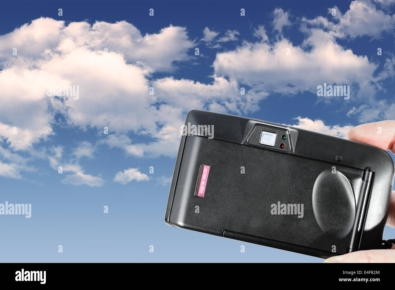 An old used film plastic camera over blue sky with clouds Stock Photo ...