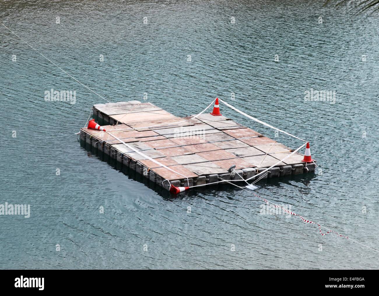 It's a photo of a raft in the middle of the sea water or lake. It is ...