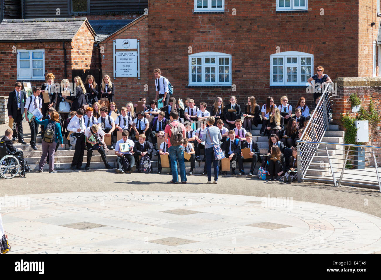 School children on trip outside lesson in uniform uniforms Cotswolds UK ...