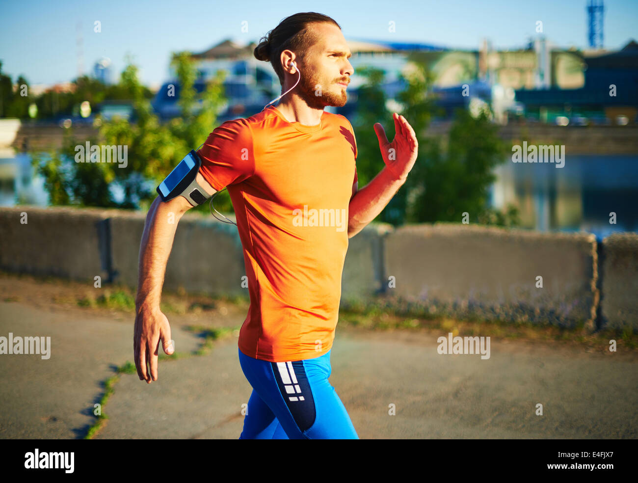 Portrait of young attractive sportsman running outside Stock Photo - Alamy
