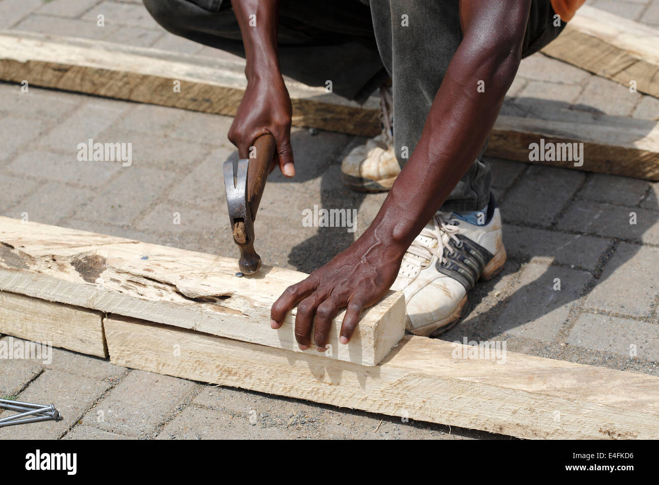 African carpenter works with wood Stock Photo - Alamy