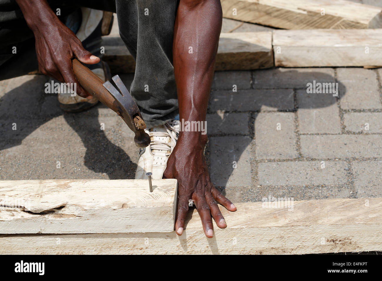 African carpenter works with wood Stock Photo - Alamy