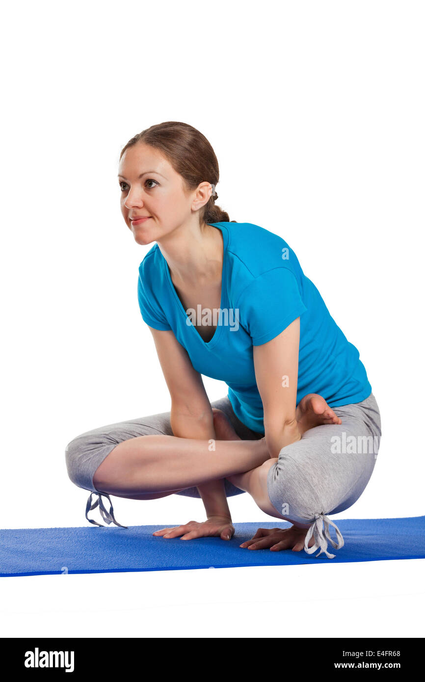 Yoga - young beautiful woman yoga instructor doing Cock Pose (Rooster ...