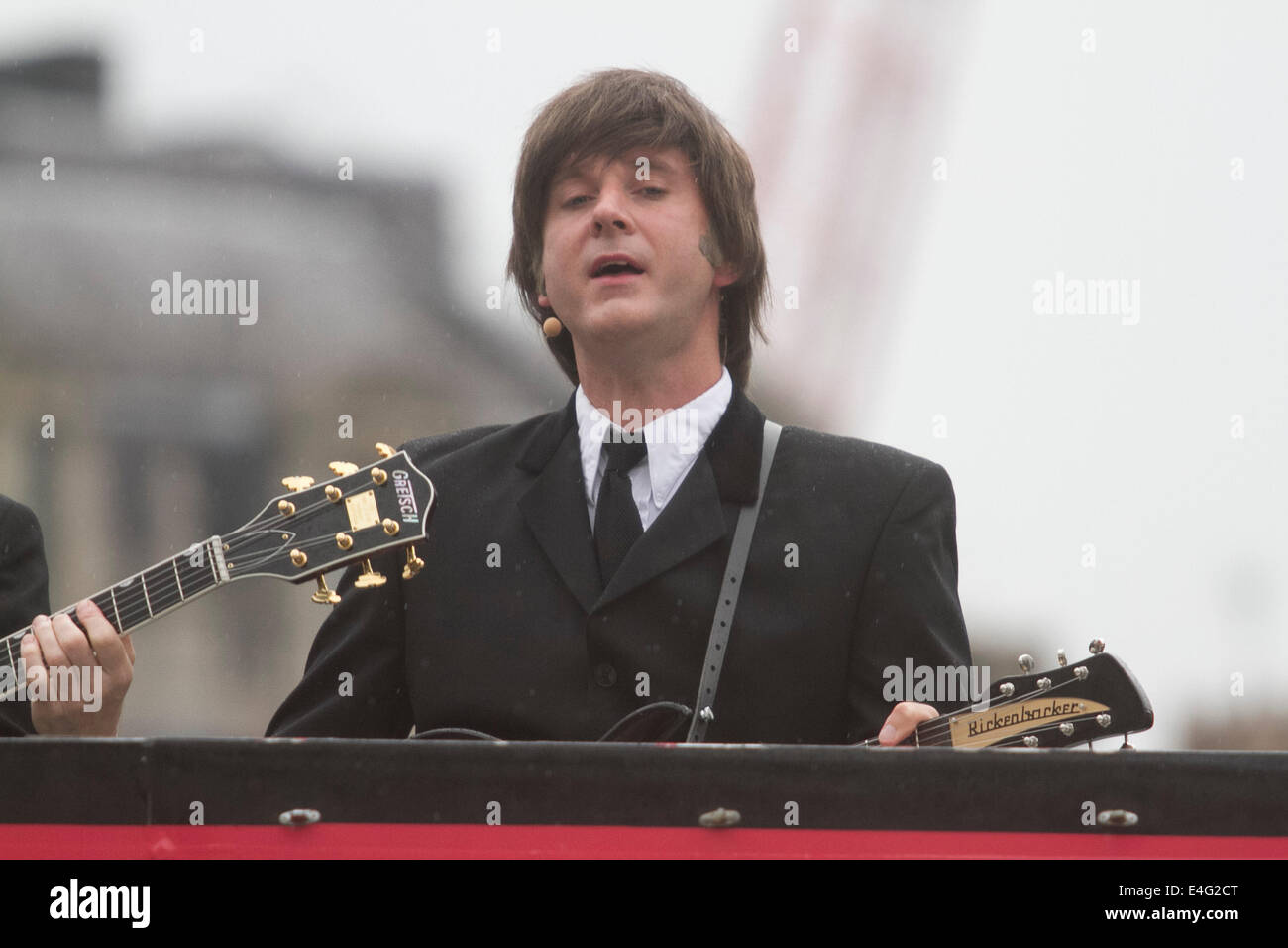 London, UK. 10th July 2014. Paul Canning performs in an open top bus as ...