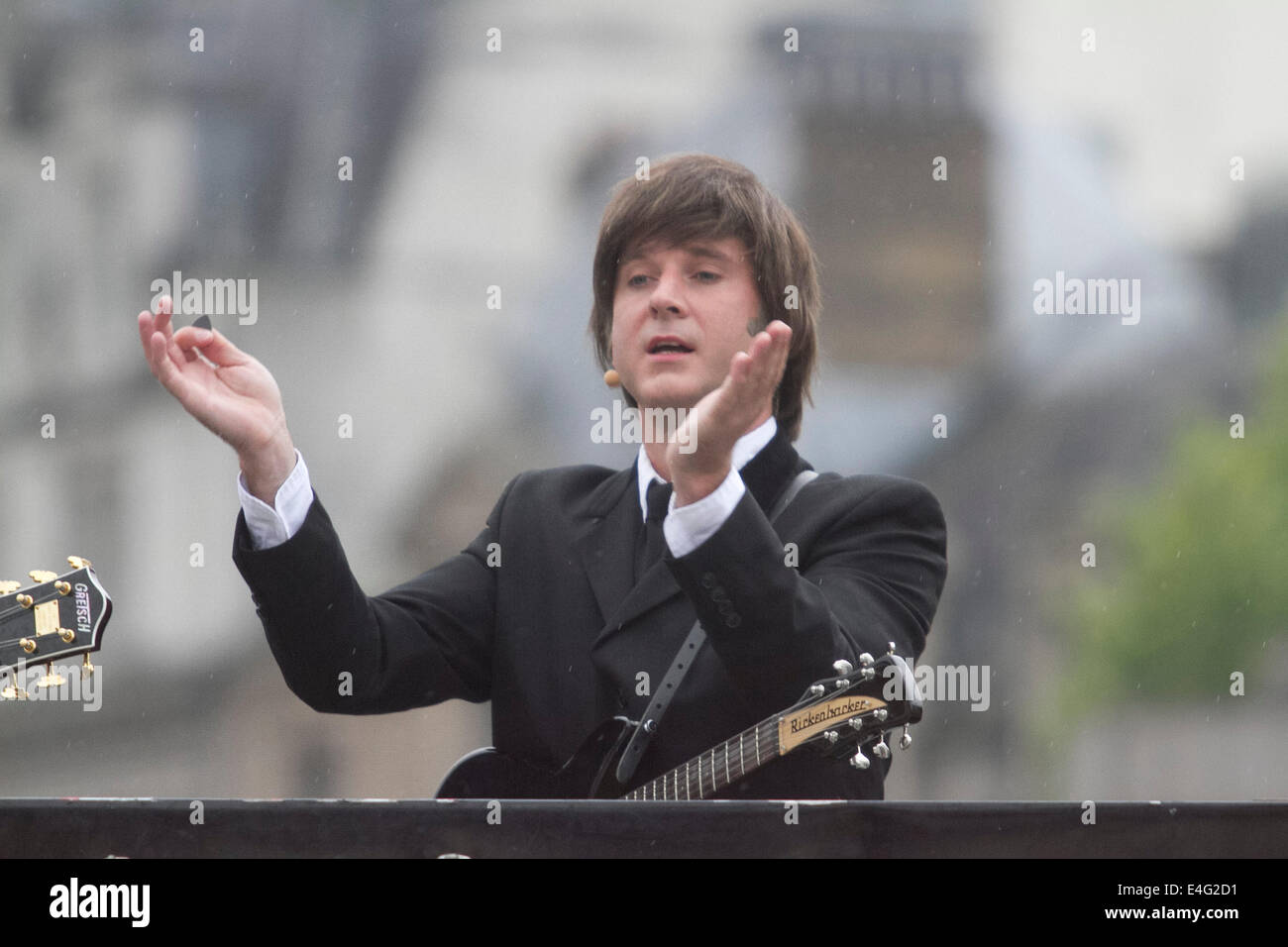 London, UK. 10th July 2014. Paul Canning performs in an open top bus as ...