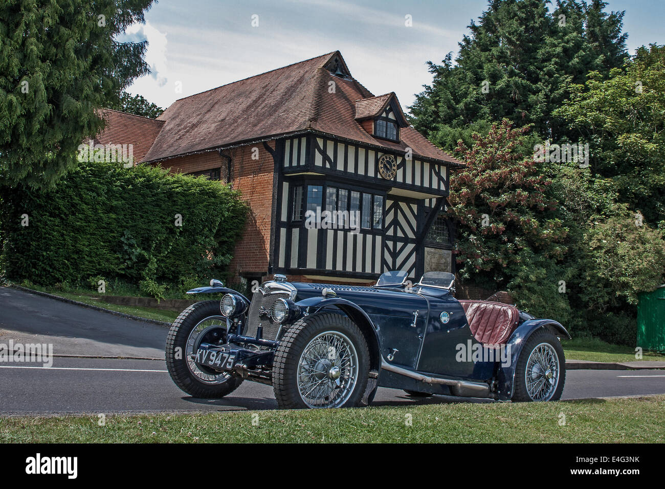 1934 Riley Ulster Imp sports car parked beside the village green in ...