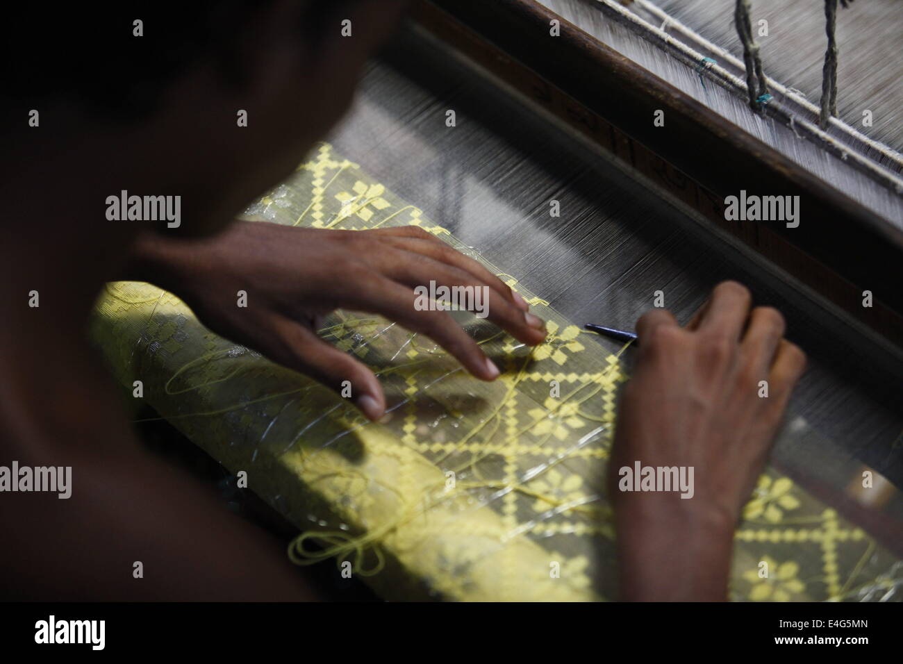 July 10, 2014 - Weavers weave famous Jamdani Saree.A sharee is the ...