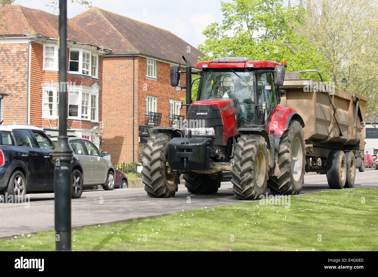 A tractor hauling a full load of manure through the small rural town of ...