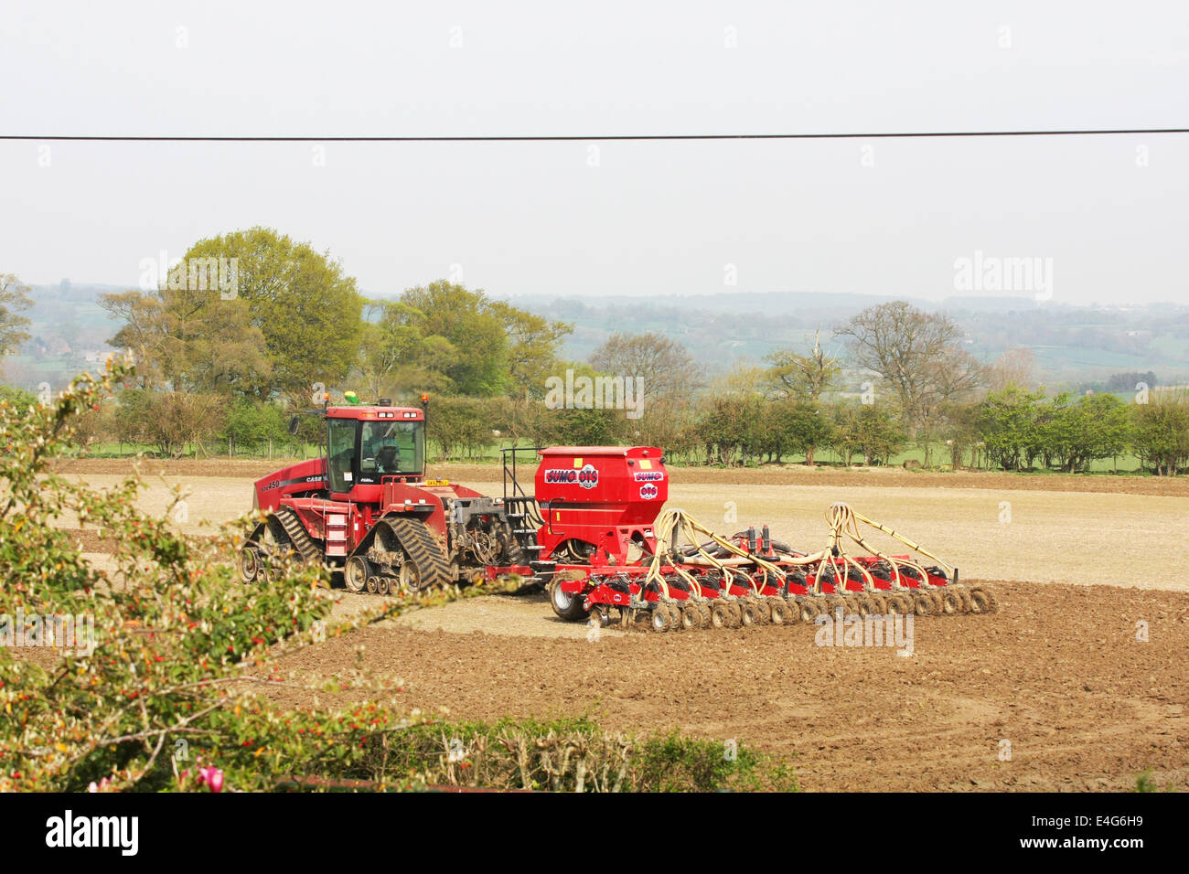 A Case STX450 tractor pulling a Sumo DTs deep tillage seeder around a ...